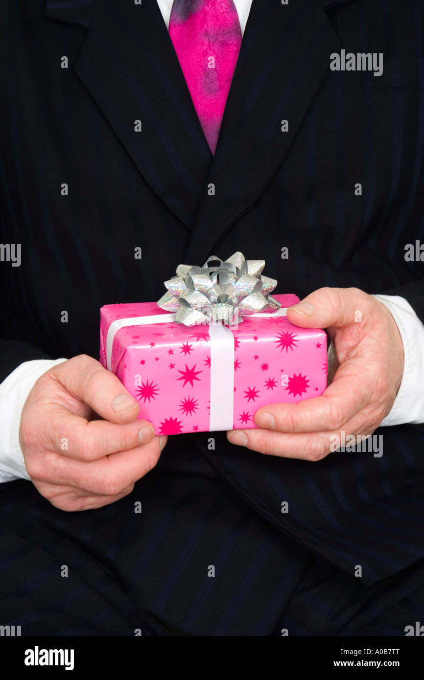 Man holding wrapped gift Stock Photo - Alamy
