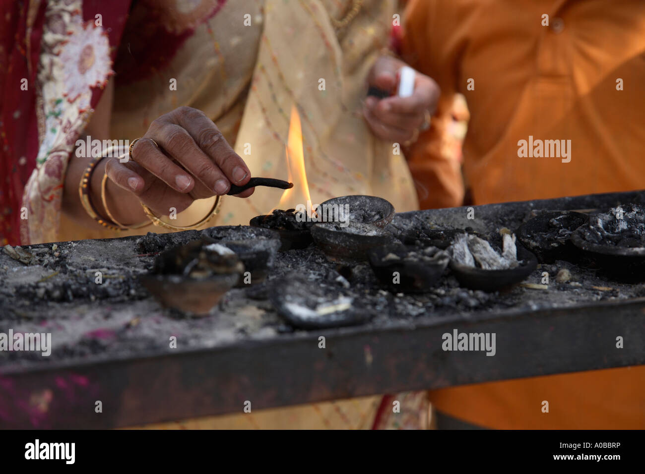 Indian woman performs worshipful puja outside a Hindu temple in Jaipur ...