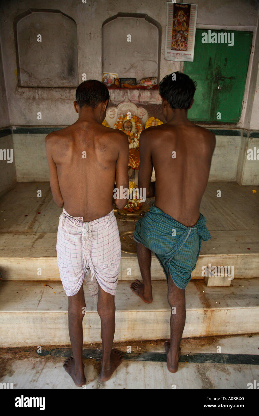 Two men perform a Hindu ritual of offering and prayer at the Galta ...
