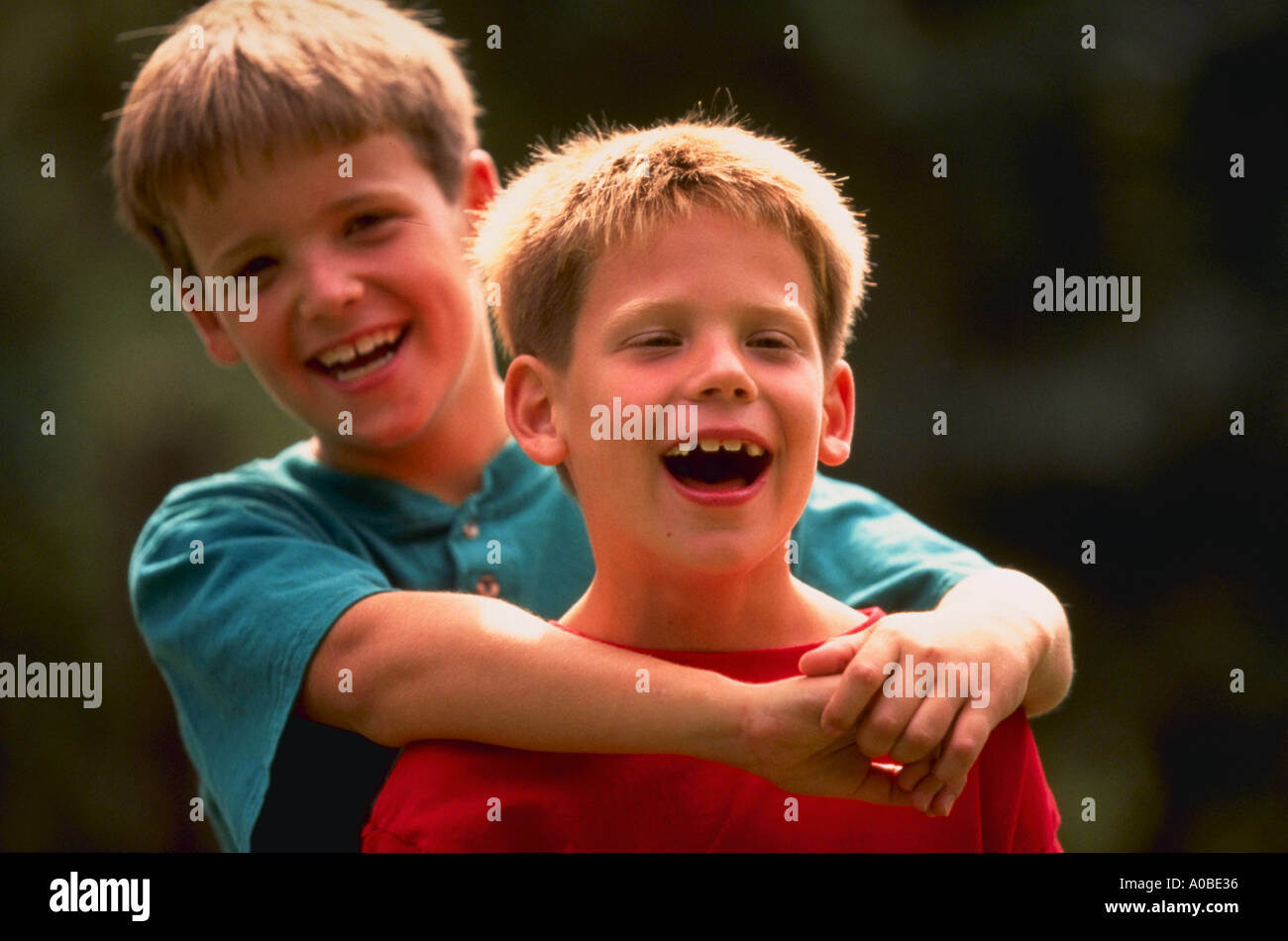 Two boys laughing and smiling together Stock Photo - Alamy