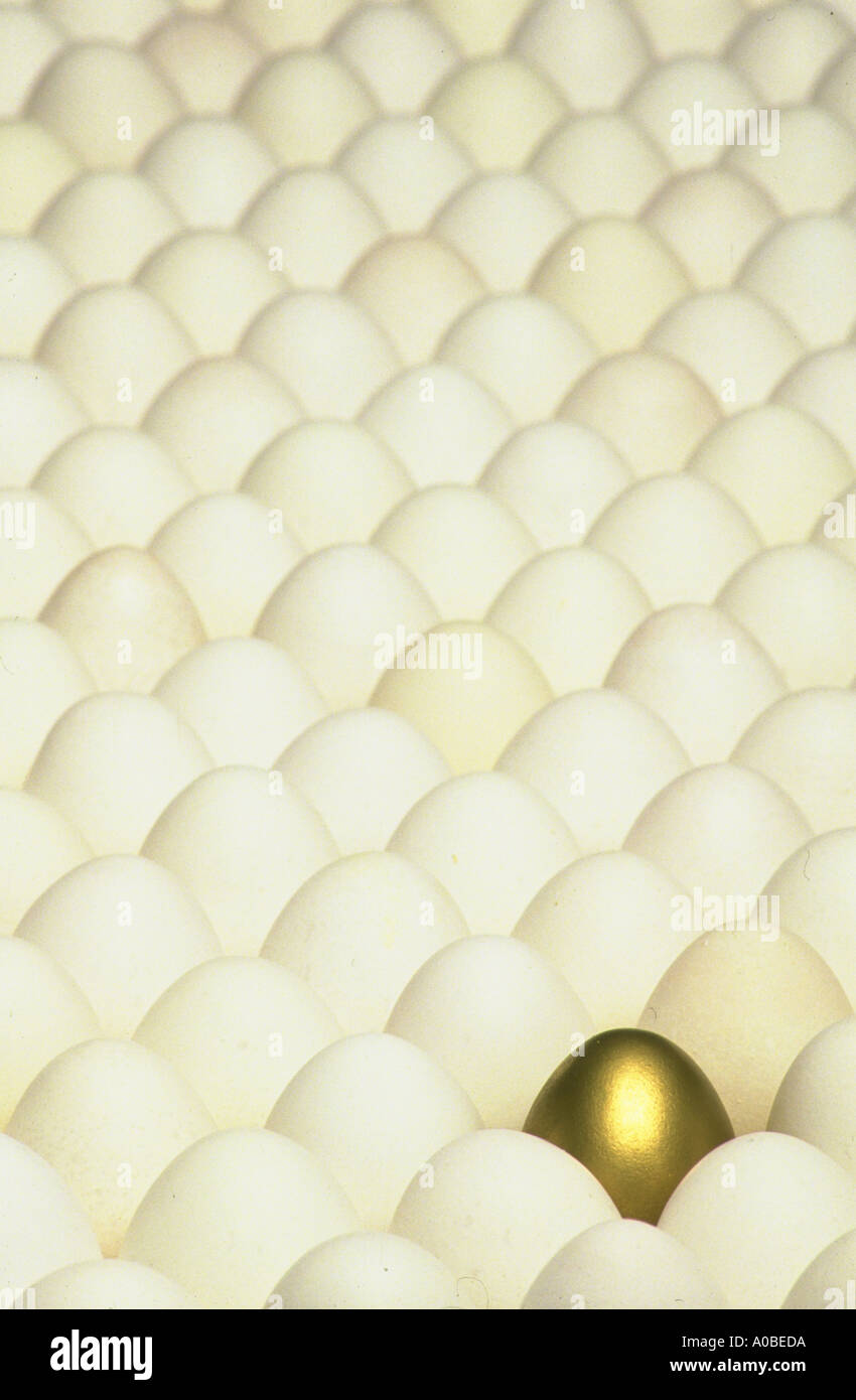 Field eggs with one golden egg Stock Photo - Alamy