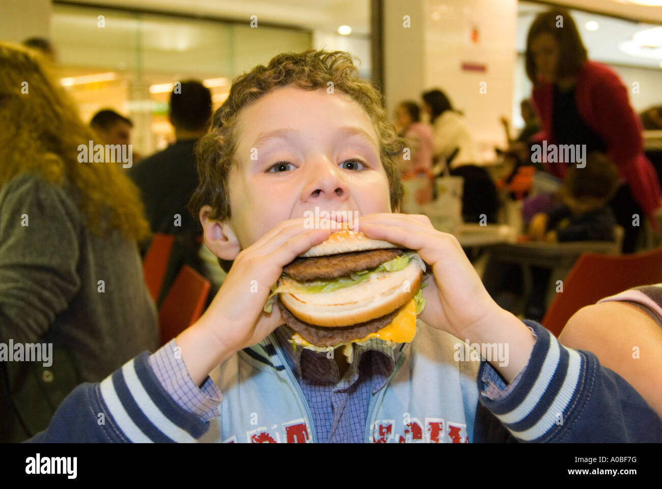 Child eating McDonald's Big Mac hamburger England UK Stock Photo - Alamy