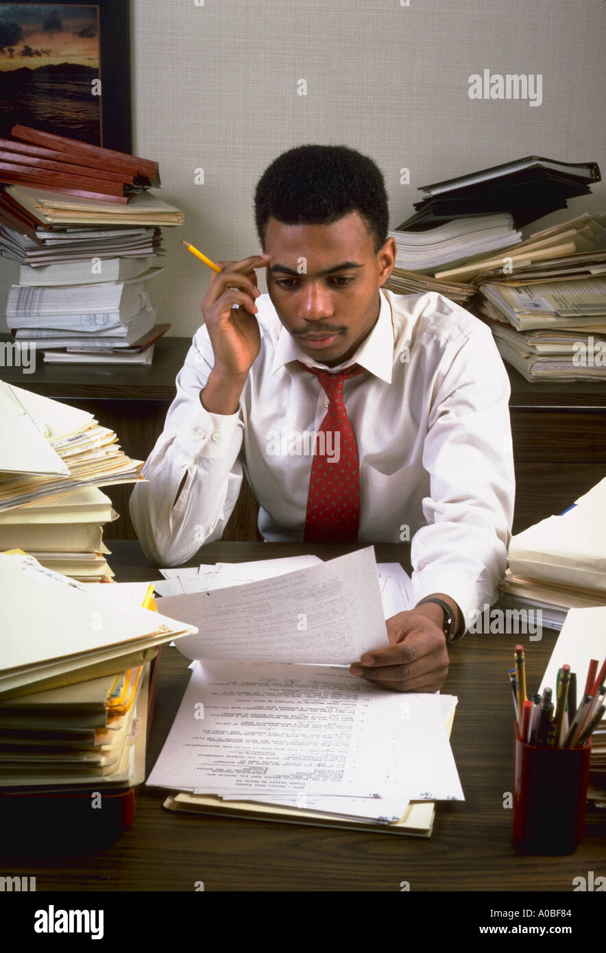 Young man overloaded with paperwork in the office released AB82148 ...
