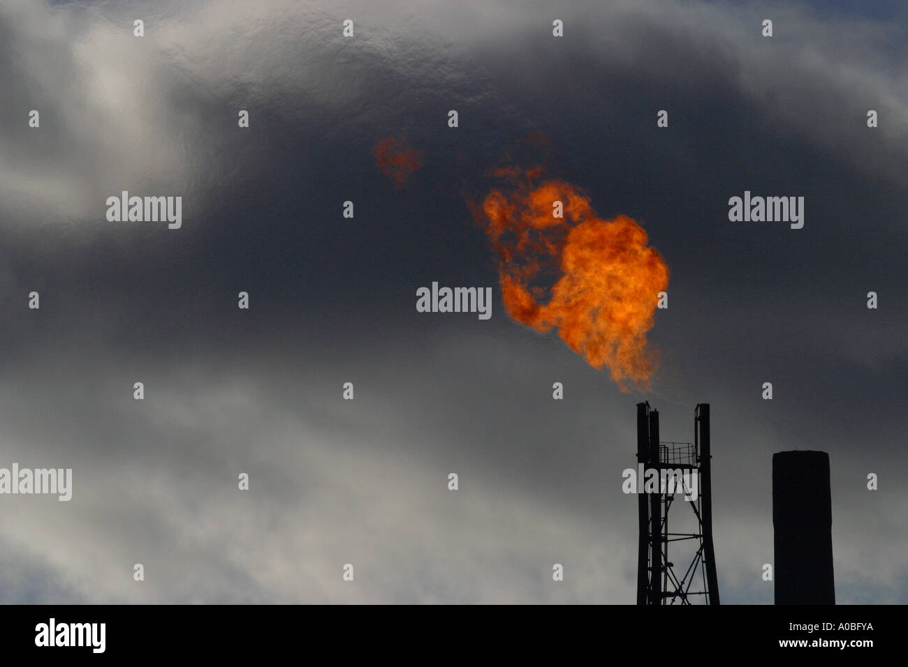 Gas flare stack burning waste gas from the SSI steel factory at Redcar ...