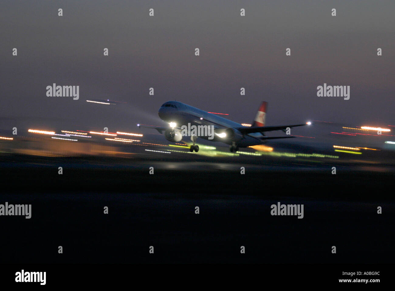 Airliner taking off at night Stock Photo - Alamy