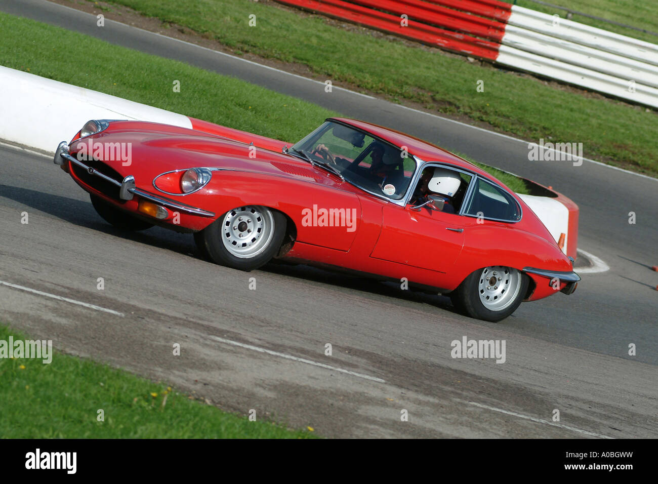 Red Jaguar E type classic sports car on race track in the uk Stock ...