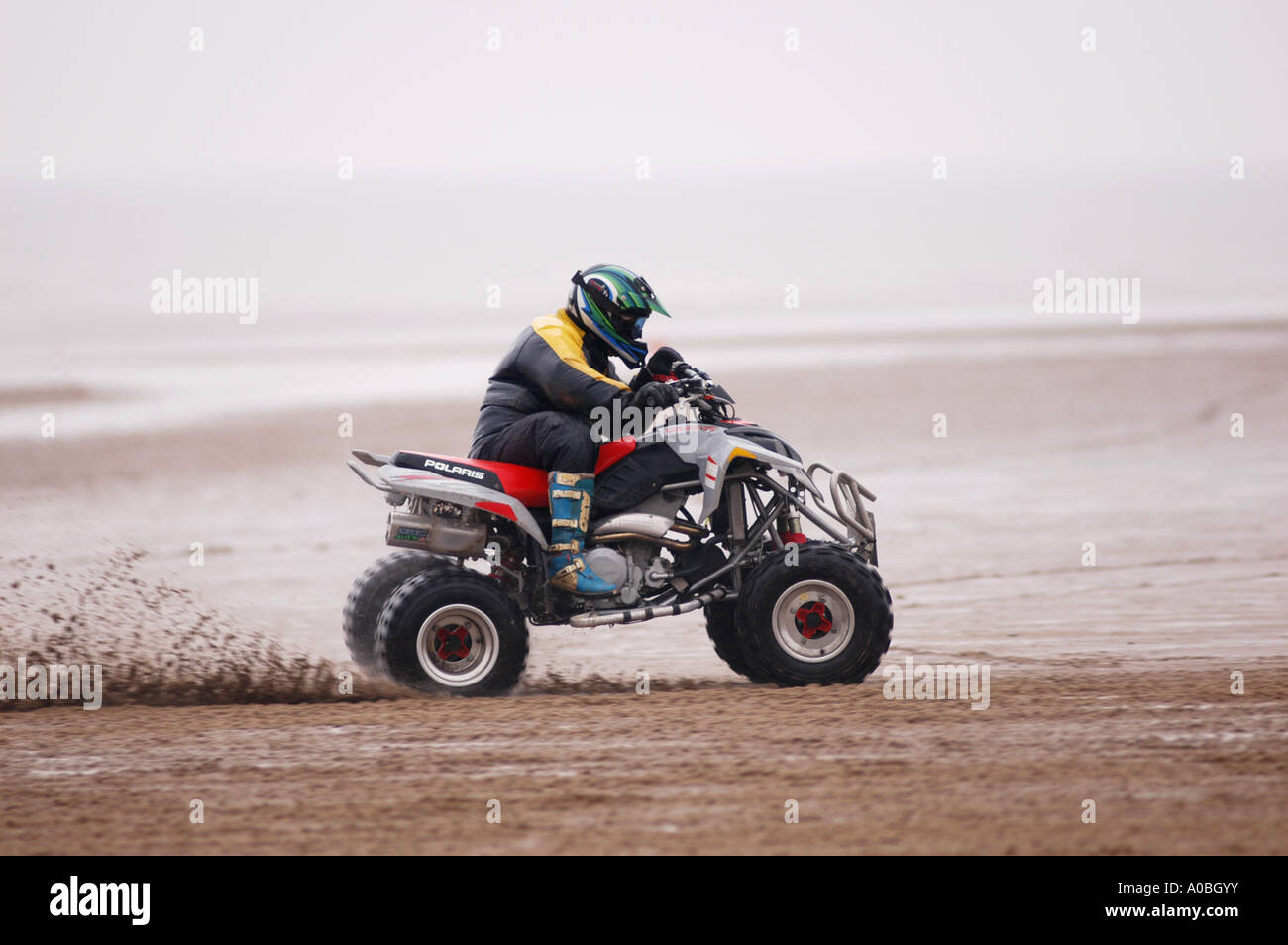 Polaris quad bike racing on a beach in the uk Stock Photo - Alamy