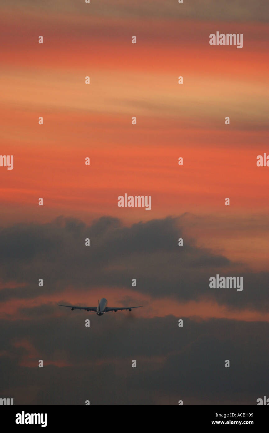 Commercial airplane climbing out after take off Stock Photo - Alamy