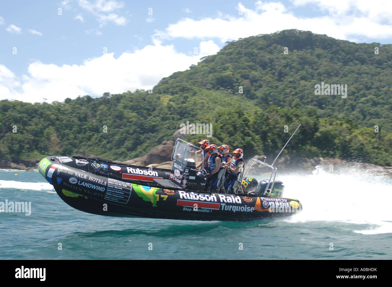 Team of people riding in a powerboat at speed Stock Photo - Alamy