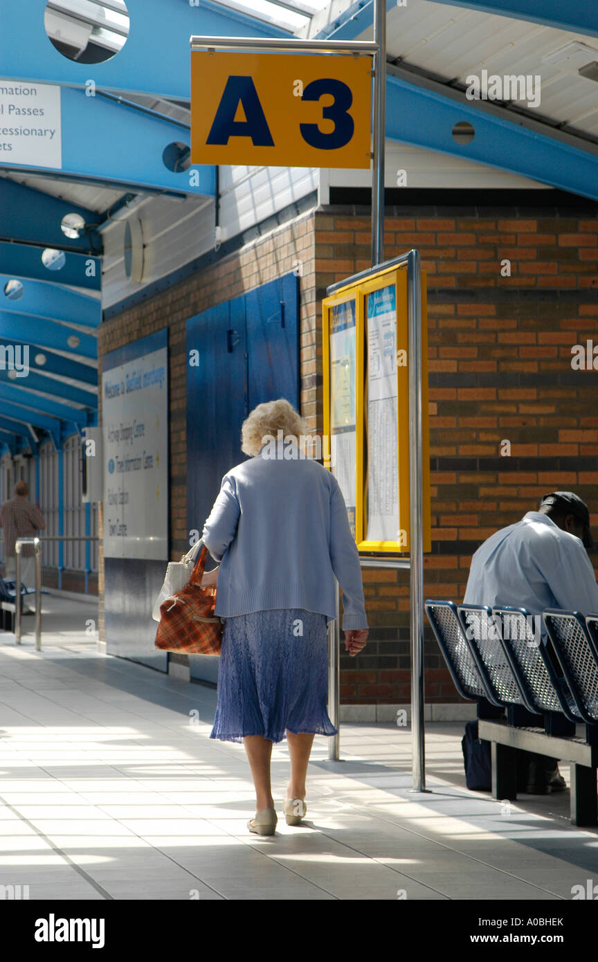 Elderly lady waiting for a bus at Sheffield bus station, england Stock ...