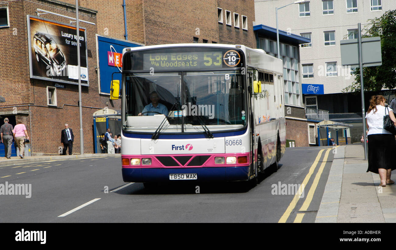 Single decker bus in First Group livery driving along a road in ...