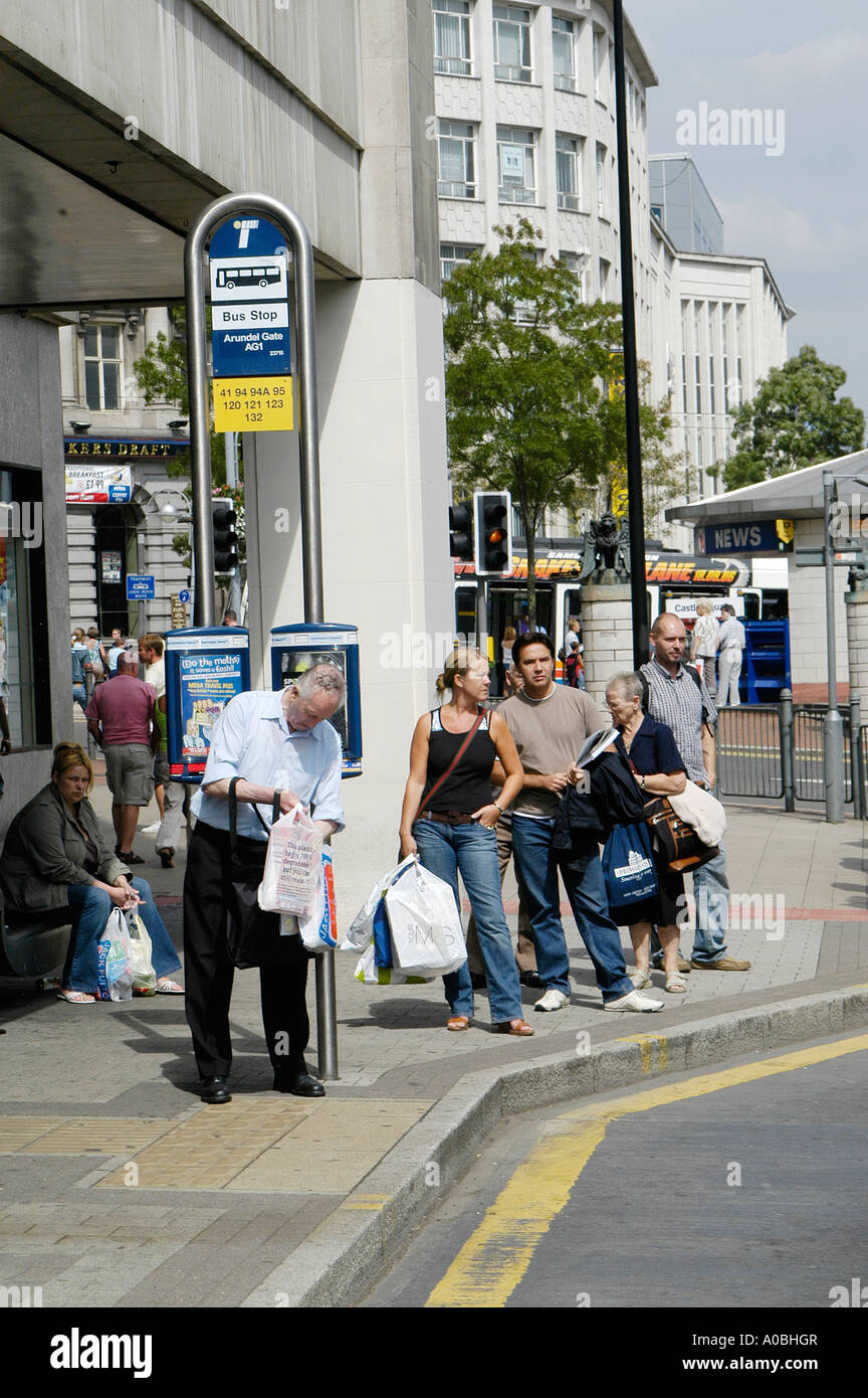 Passengers waiting at a bus stop in Sheffield Stock Photo - Alamy