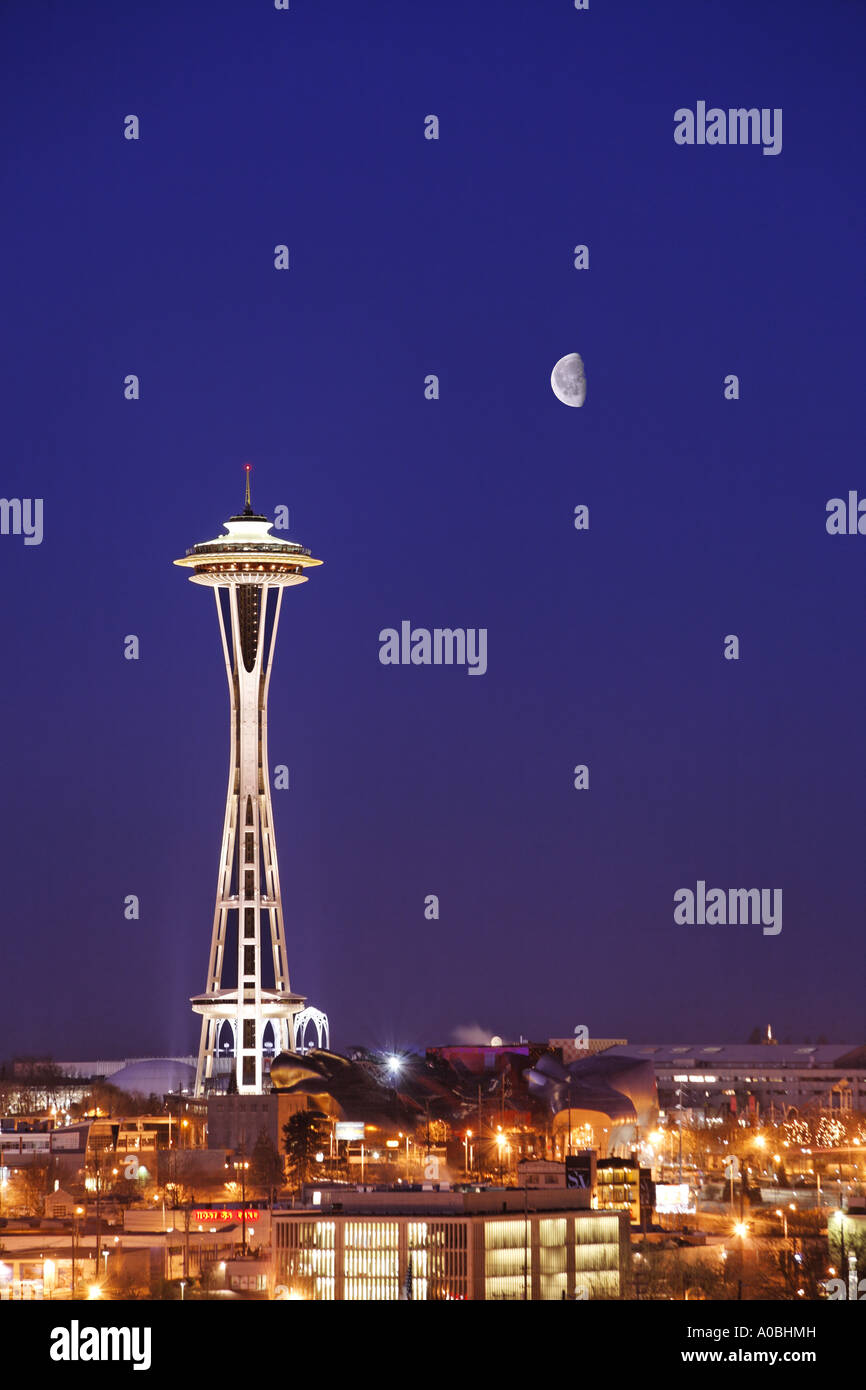 The Seattle Space Needle stands under a quarter moon in a twilight sky ...