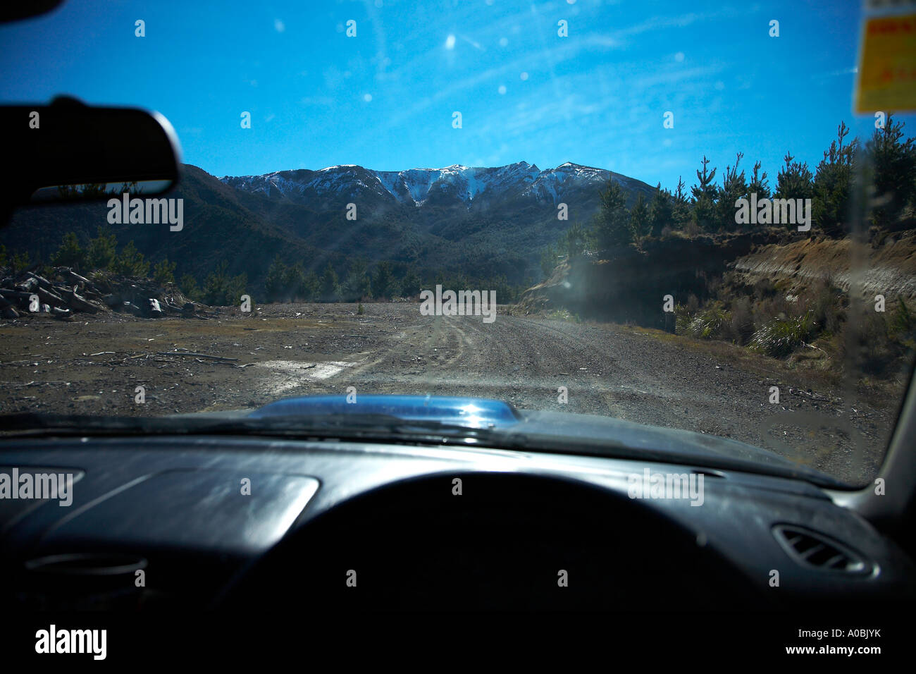 off road driving in the mountains through the dashboard of the car ...