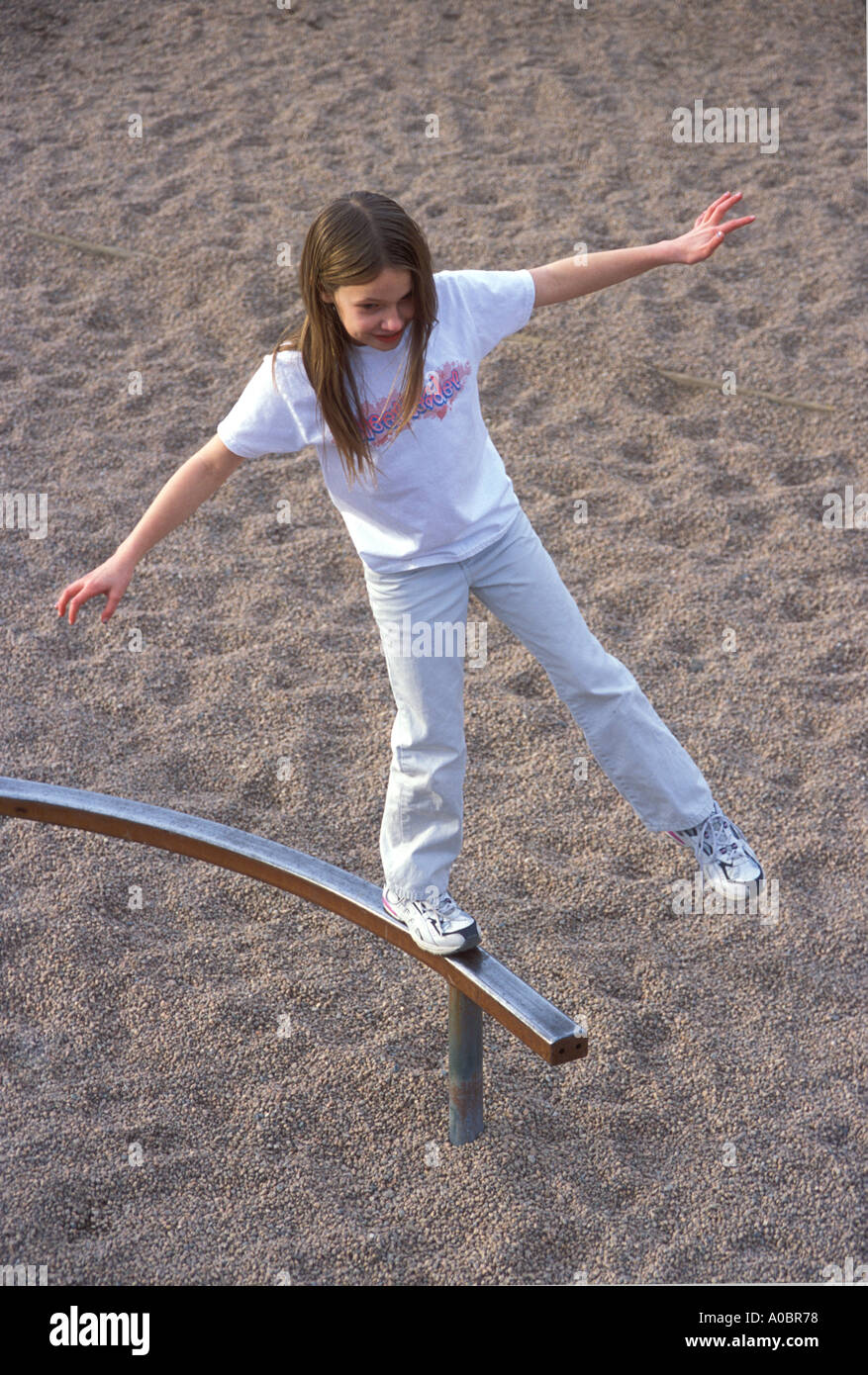 Young girl balances at a playground balance beam Stock Photo - Alamy