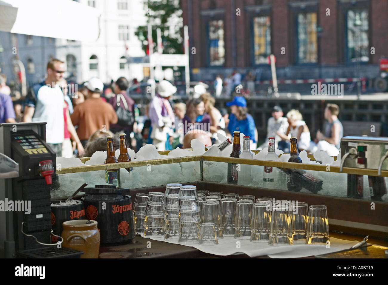 Empty glasses and beer bottles in ice on bar counter and people, Nyhavn ...