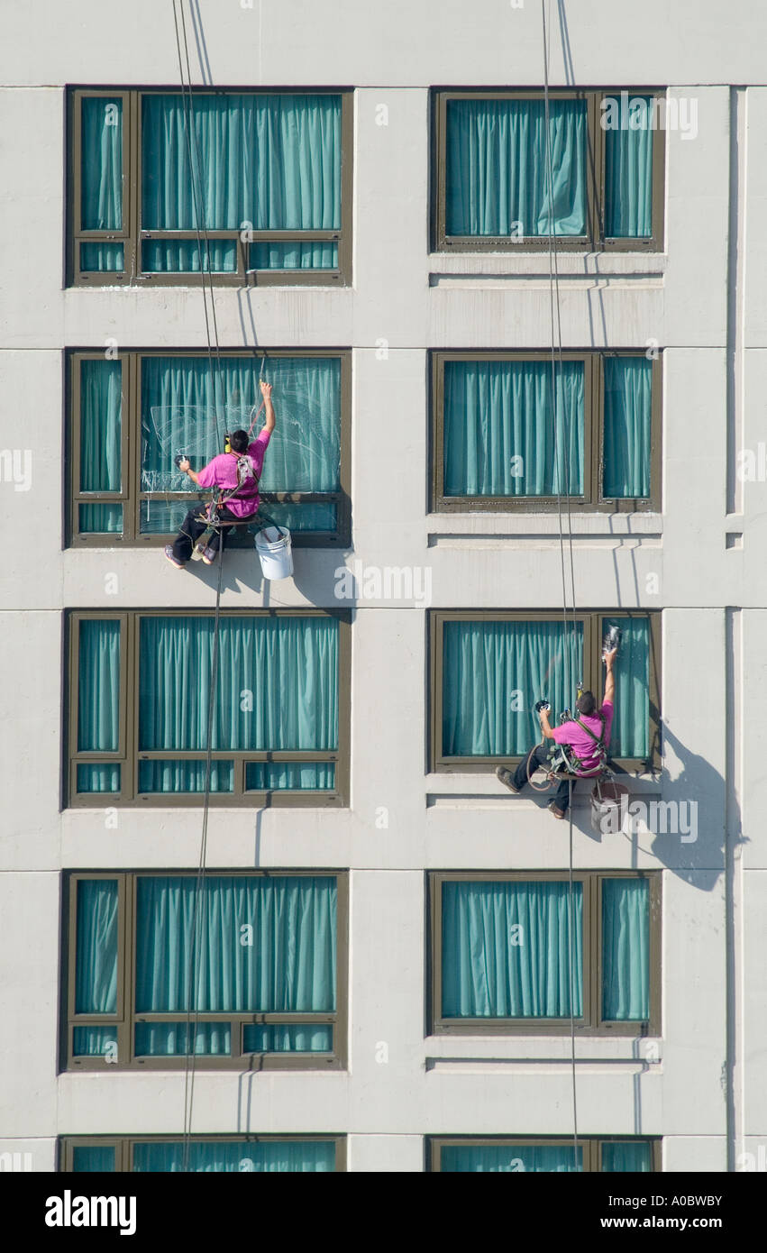 Two workers clean the exterior of a building hi-res stock photography ...