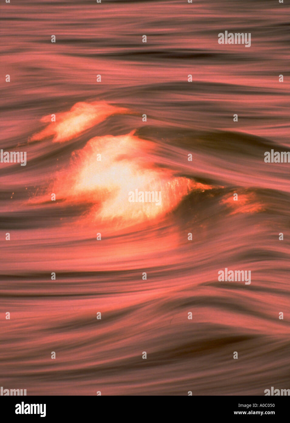 Small wave cresting and breaking with blurred effect Stock Photo - Alamy