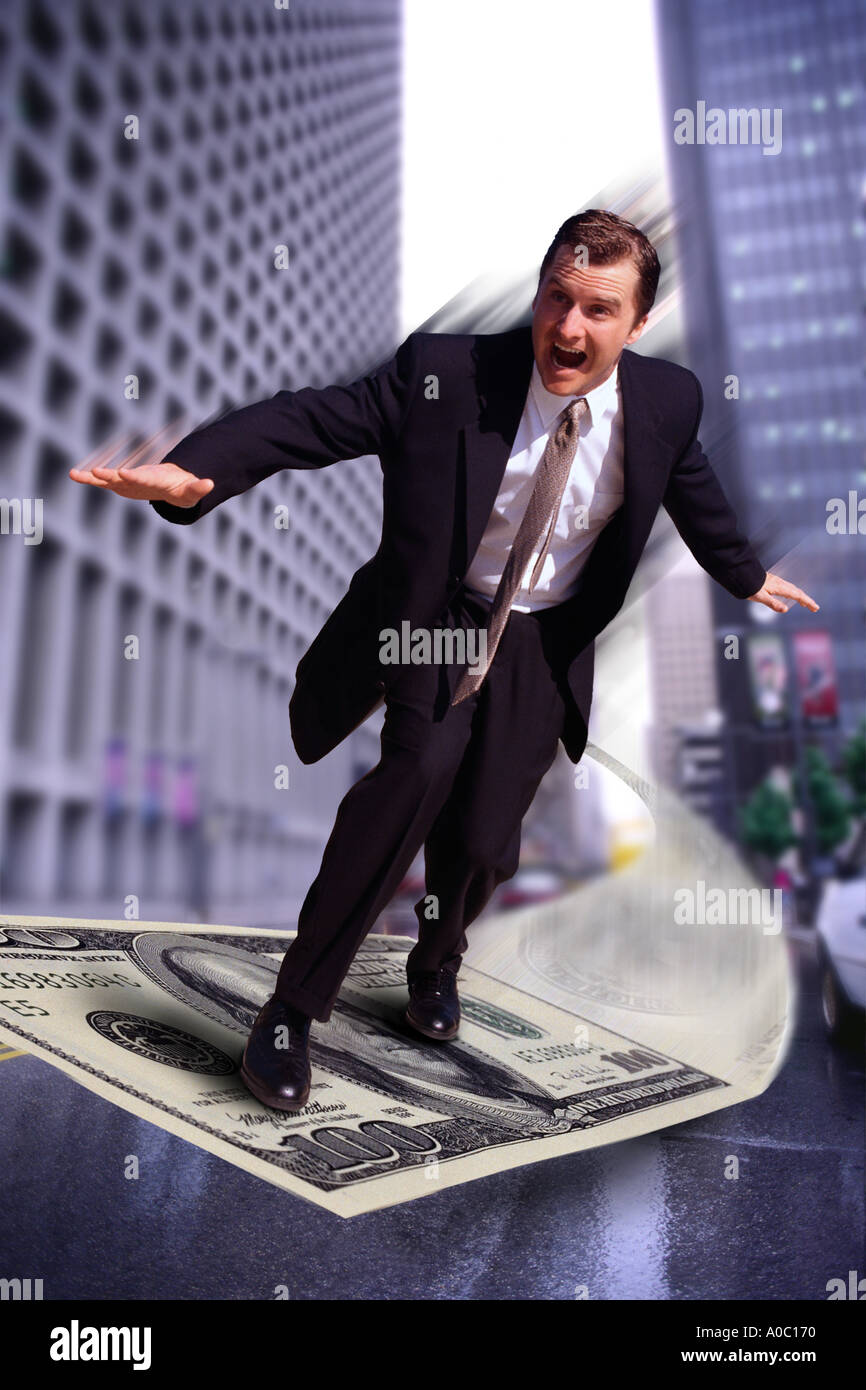 Businessman flying on money Stock Photo - Alamy