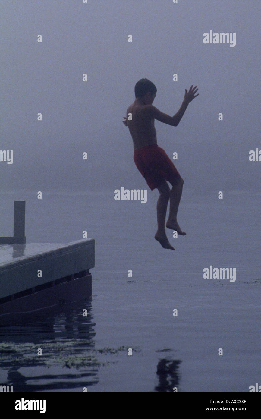 Boy jumping into water Stock Photo - Alamy