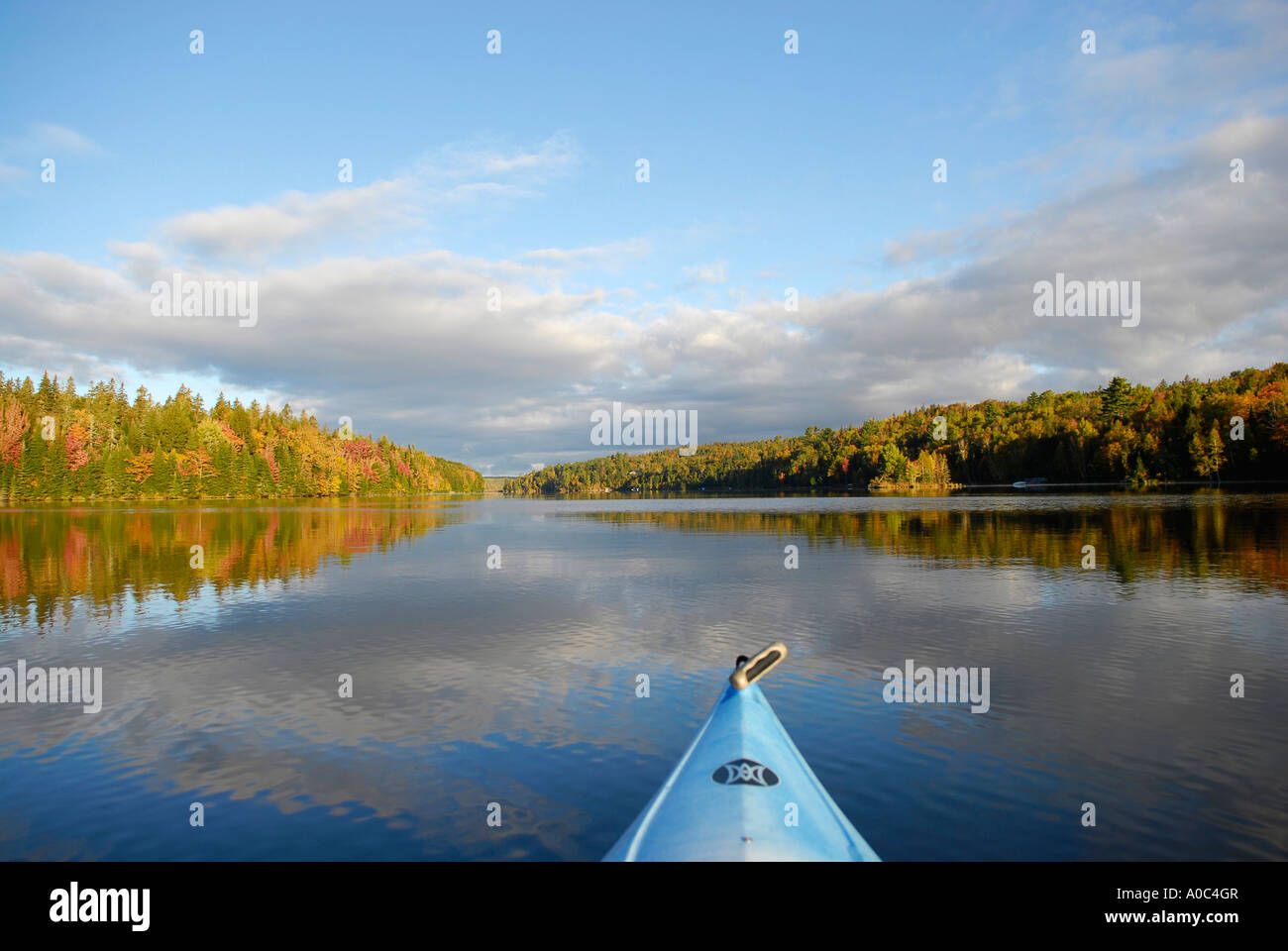 Stock image of a kayak on a lake with fall colours Stock Photo - Alamy