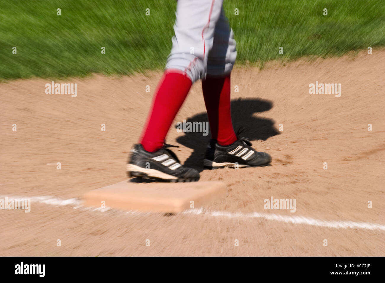 Preteen boy standing on first base during a Little League baseball game ...