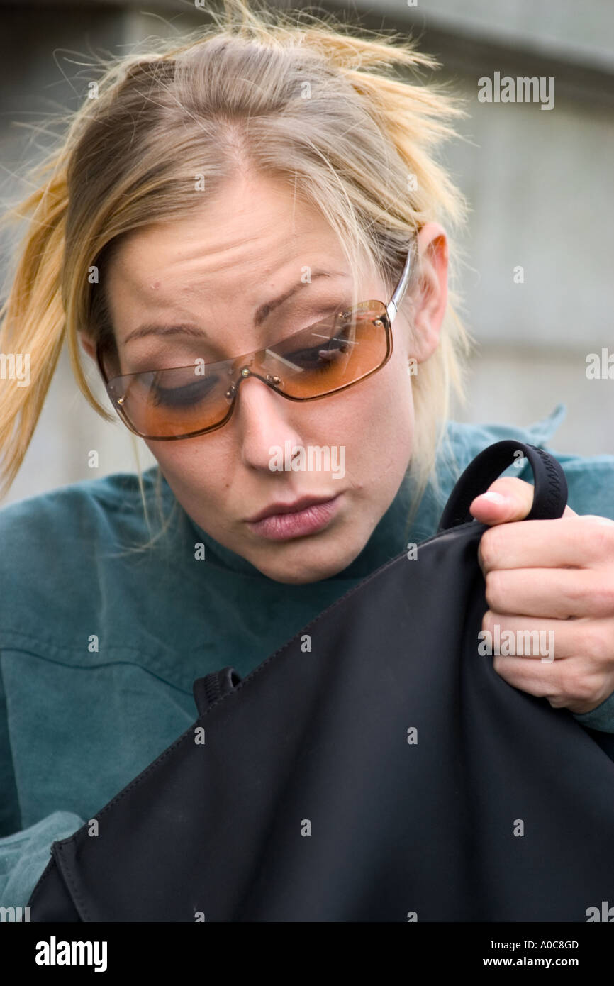 Searching in her pocketbook hi-res stock photography and images - Alamy