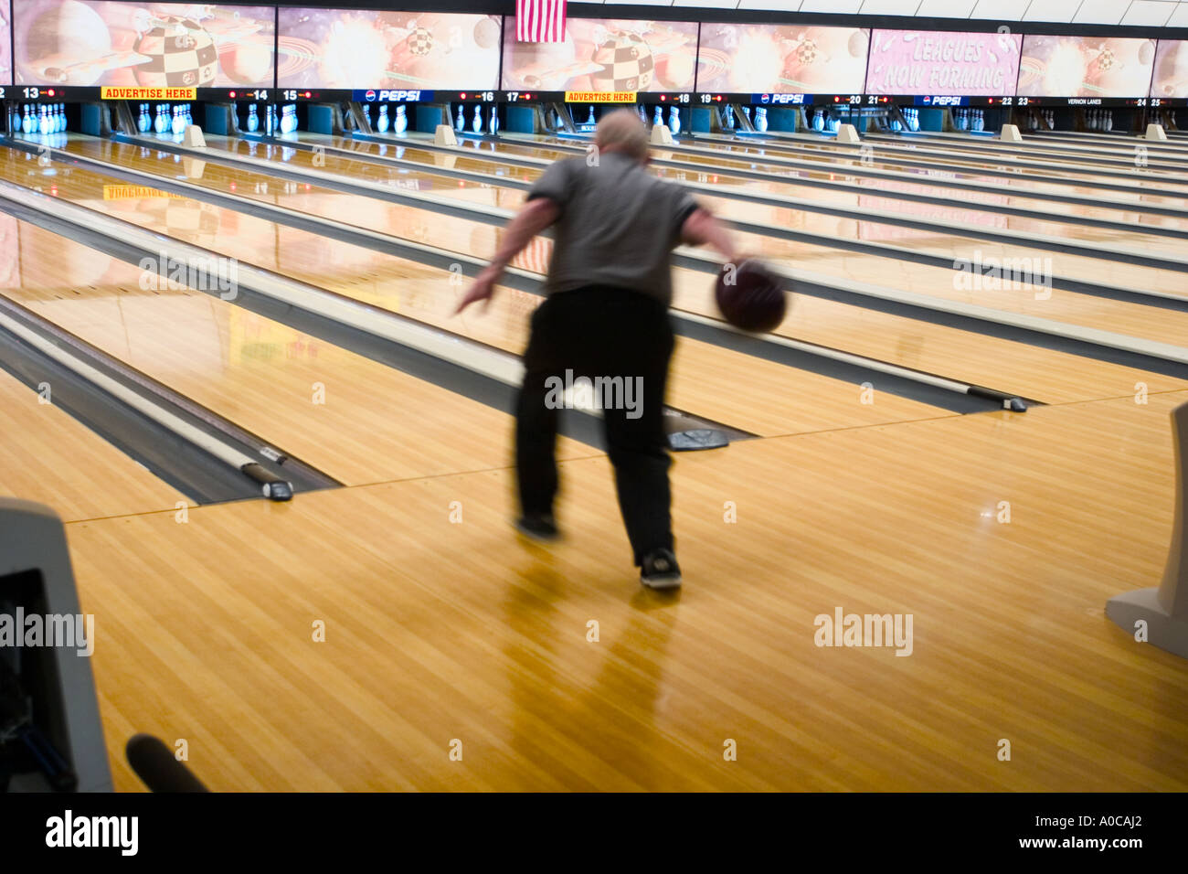 Older man bowling Stock Photo - Alamy