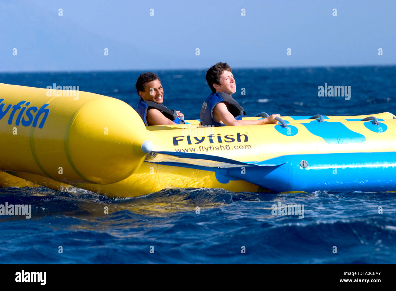 fun in riding an inflatable boat pulled by an outboard motor Stock ...