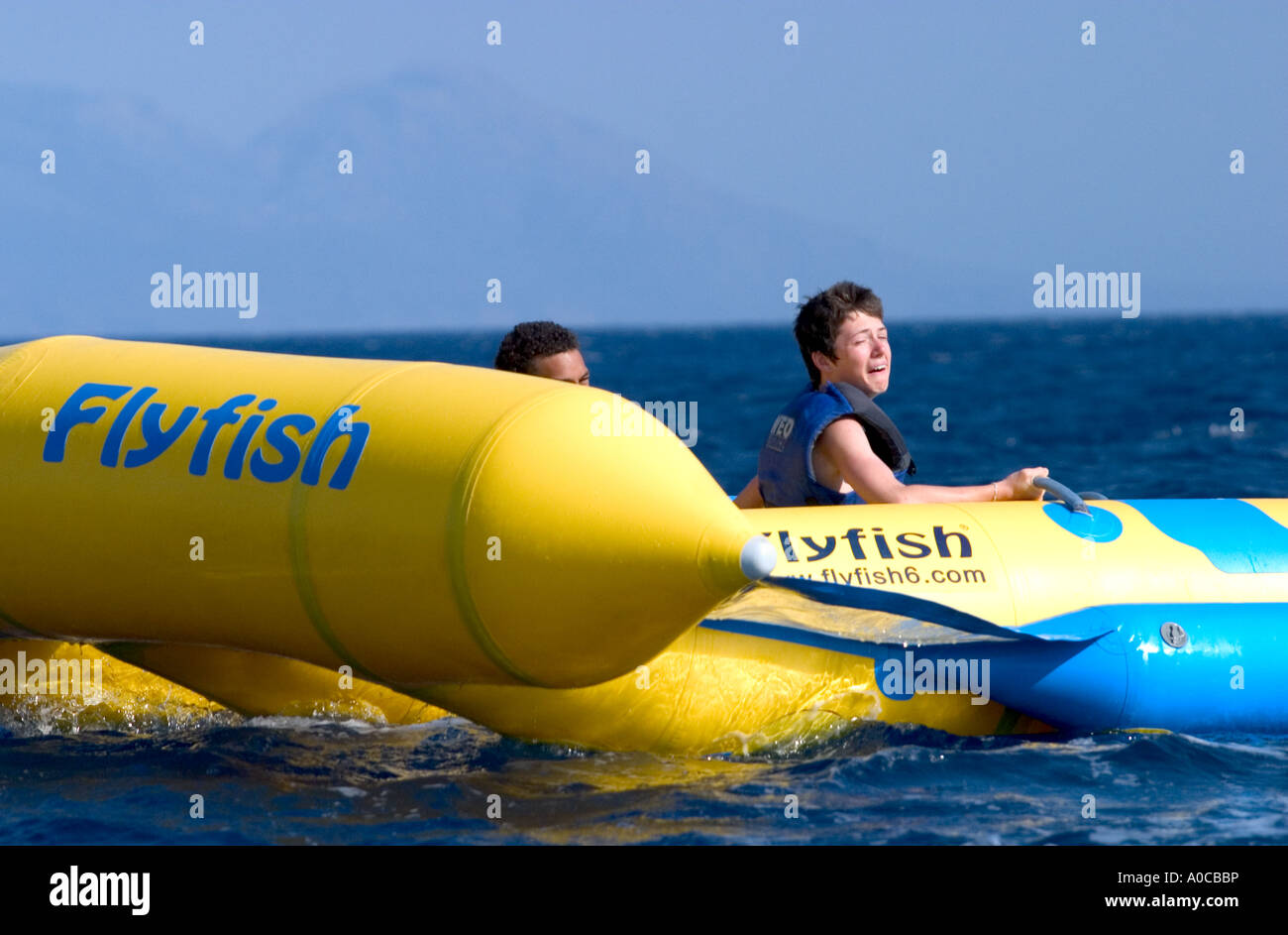 fun in riding an inflatable boat pulled by an outboard motor Stock ...