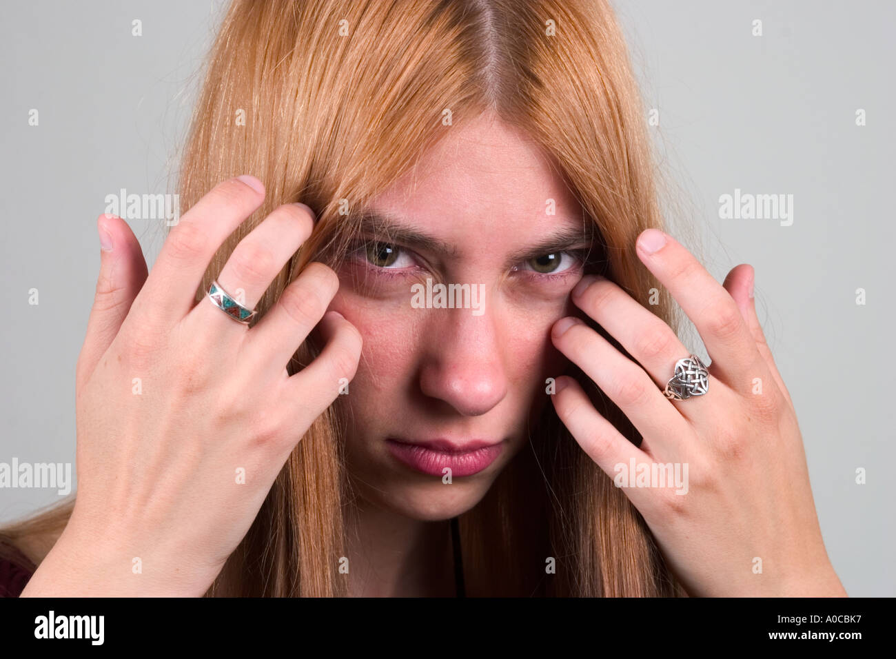 Young woman adjusting her long red hair Model Released Stock Photo - Alamy