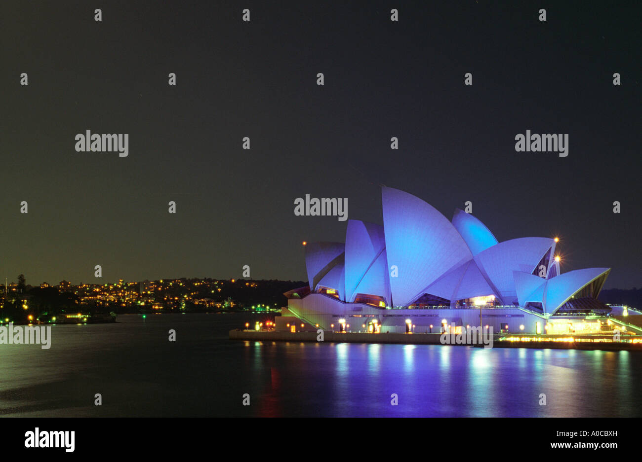 Sydney opera House by night floodlit in blue Stock Photo - Alamy
