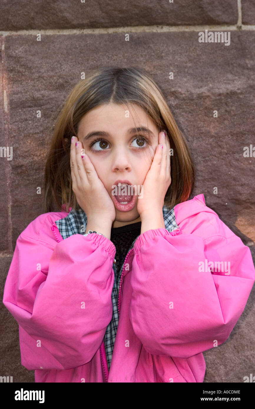 Young girl with her hands on her face Stock Photo - Alamy