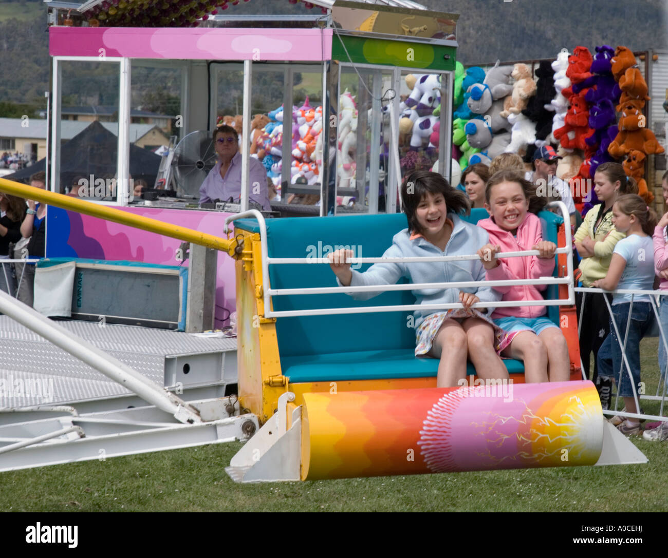 Two young girls on a fun fair ride Stock Photo - Alamy