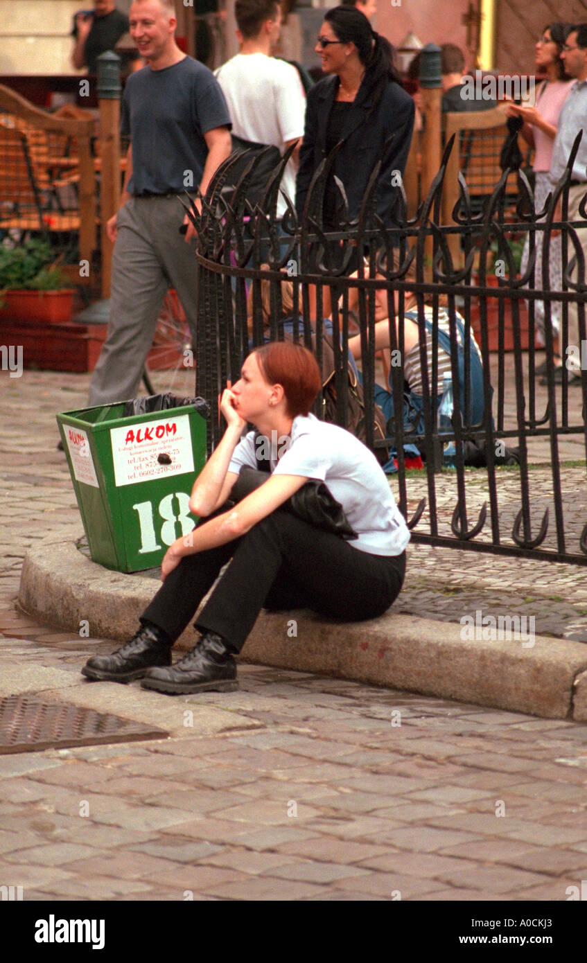 Woman sitting on curb waiting hi-res stock photography and images - Alamy