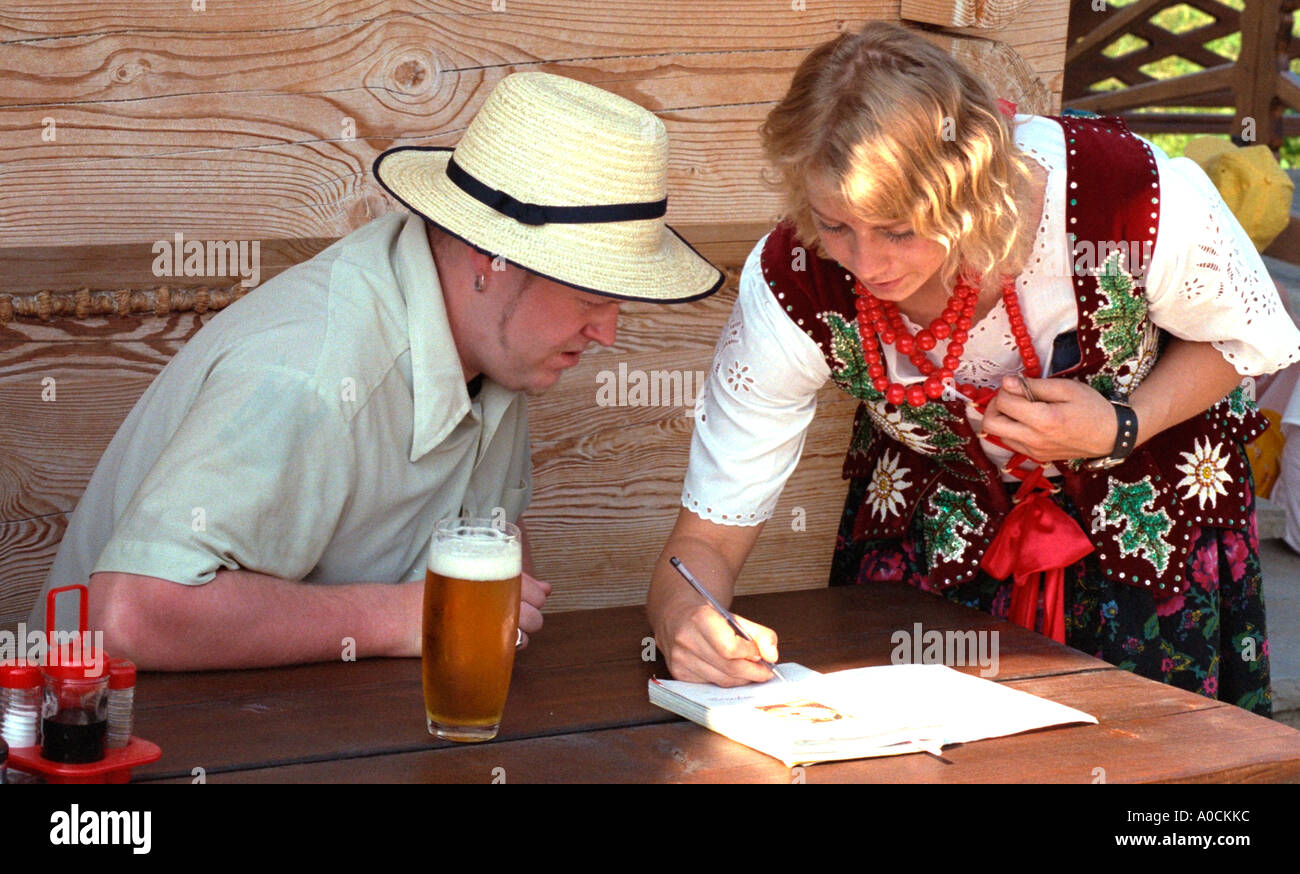 Waitress helping young visitor with directions age 25. Zakopane Poland ...