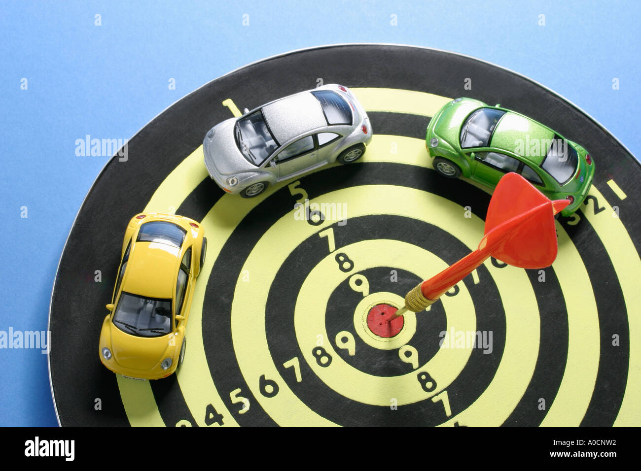 Miniature Cars and Dart on Dartboard Stock Photo - Alamy