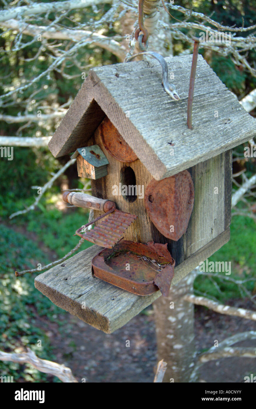 A rustic birdhouse is made with old tools and tin cans in Occidental ...