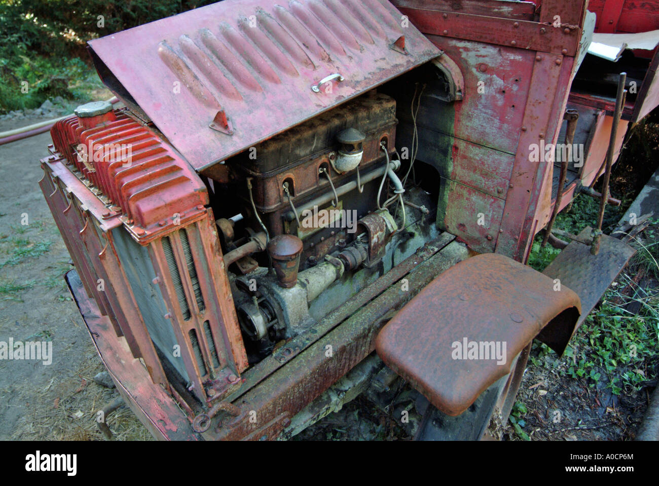 The engine compartment is open showing the engine of an old dusty ...