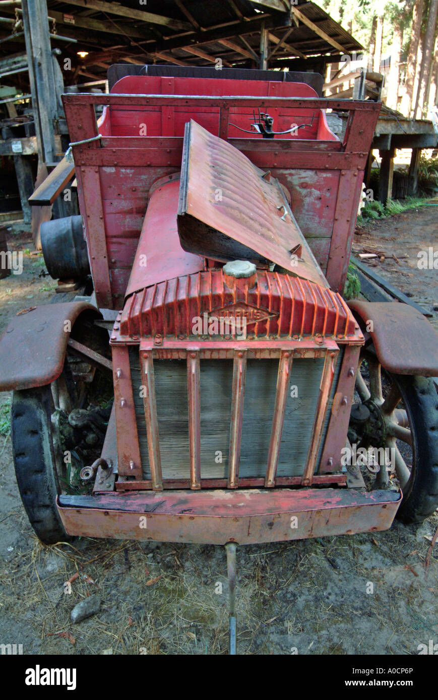 Side view of an old antique red 1924 Dorris flatbed truck used as a ...