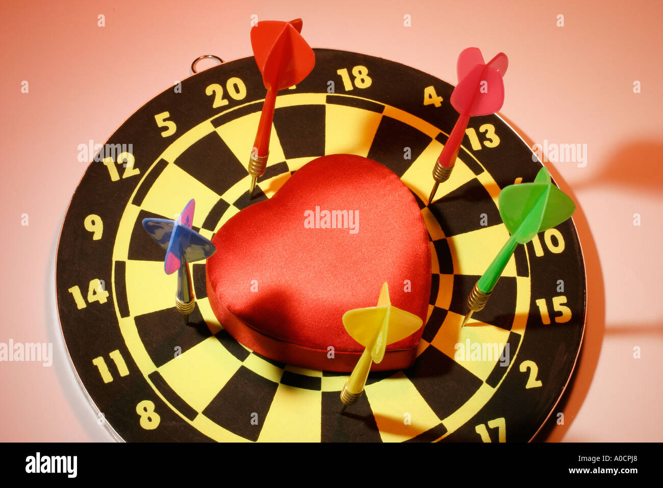 Red Heart and Darts on Dartboard Stock Photo - Alamy