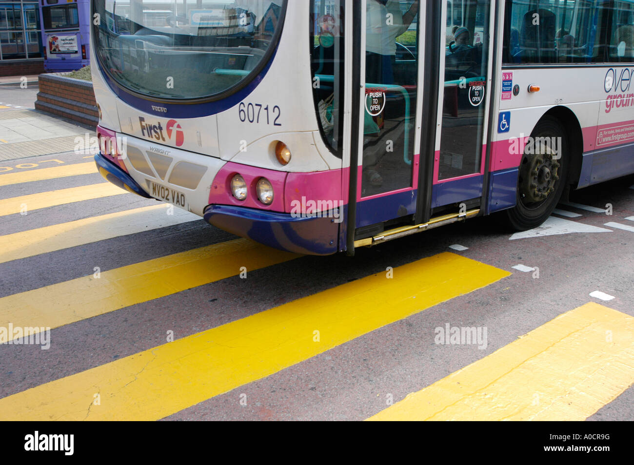 A single decker bus passing over a speed ramp outside a bus station, a ...