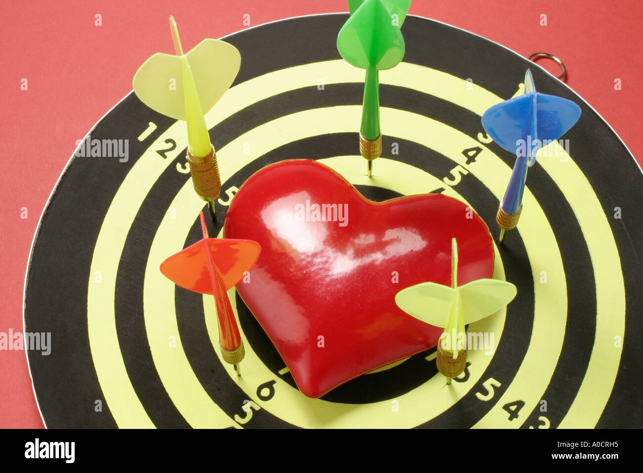Red Love Heart and Darts on Dartboard Stock Photo - Alamy
