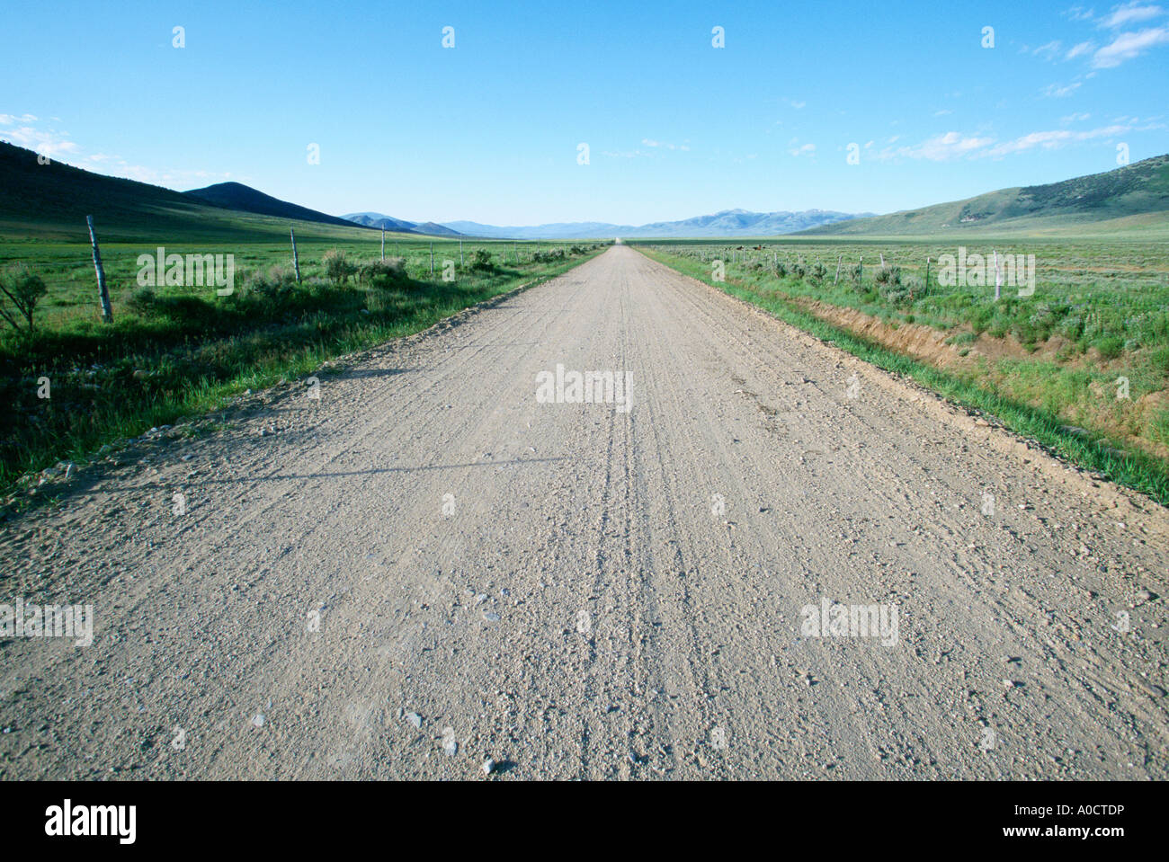 Straight dirt road stretching into distance in rural Southern Idaho USA ...