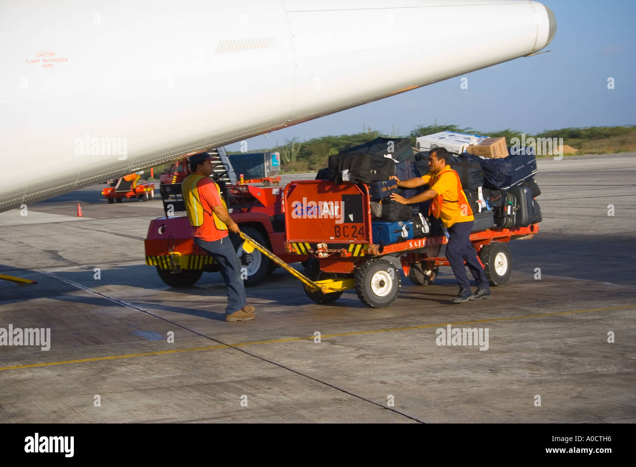 Luggage loading on airport of Aruba Stock Photo - Alamy