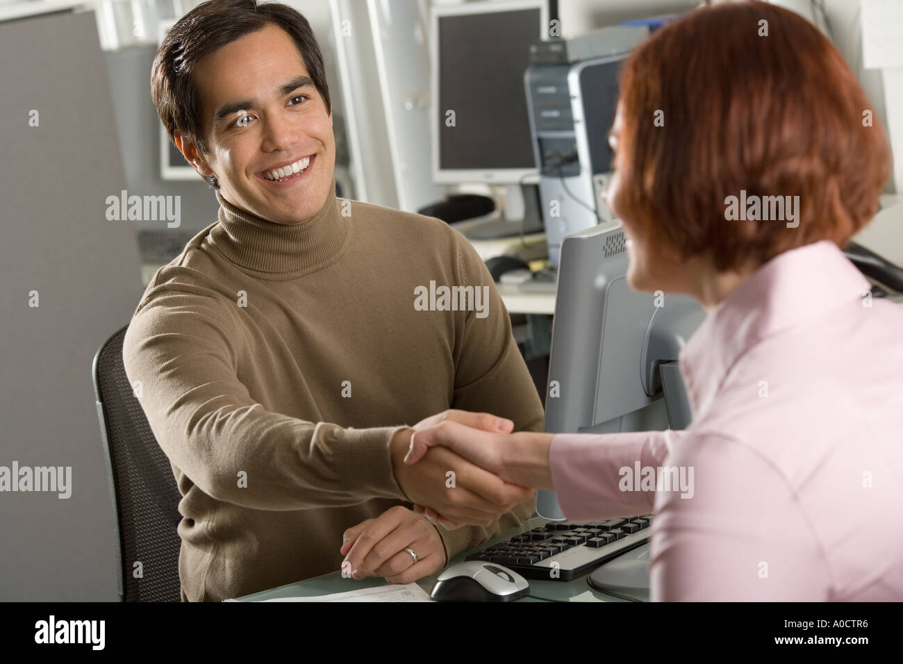 Businessman shaking hands in office Stock Photo - Alamy