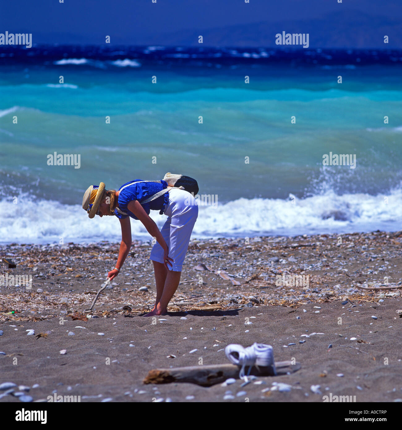 WOMAN SEARCHING ON A STORM STREWN BEACH Stock Photo - Alamy