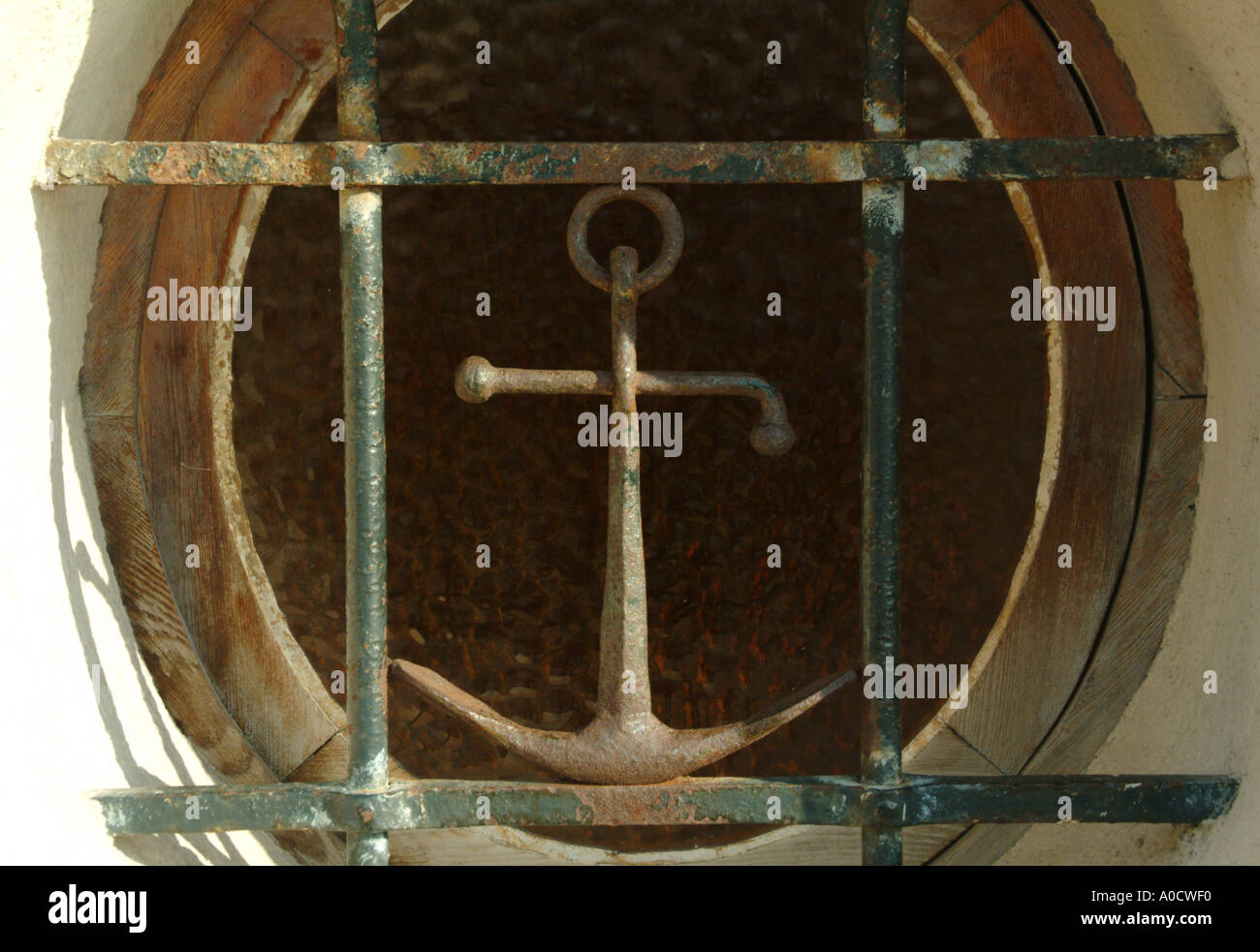 a window grill in the shape of an anchor over a circular window in Nice ...