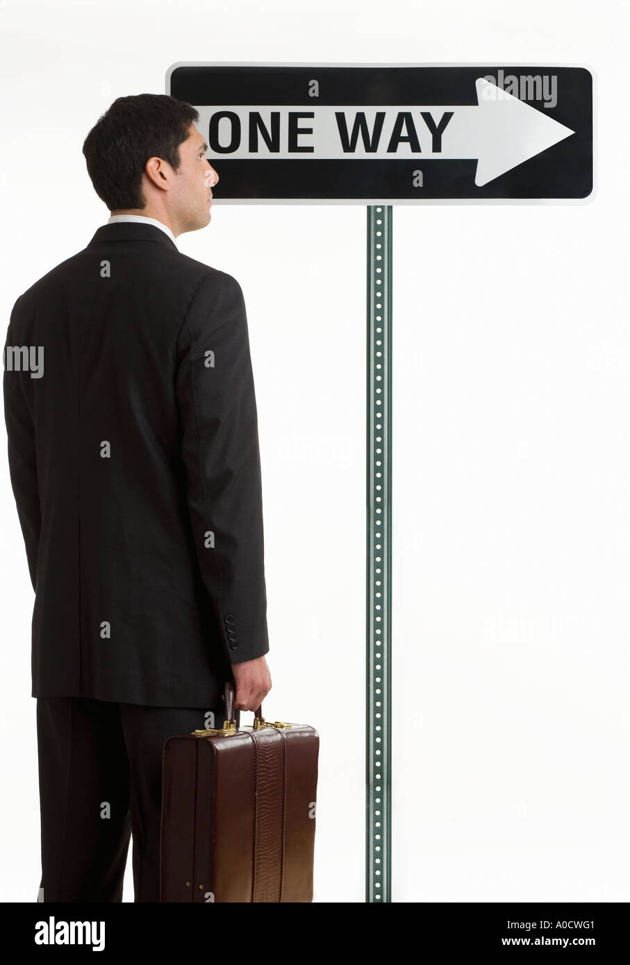 Businessman at one way sign Stock Photo - Alamy