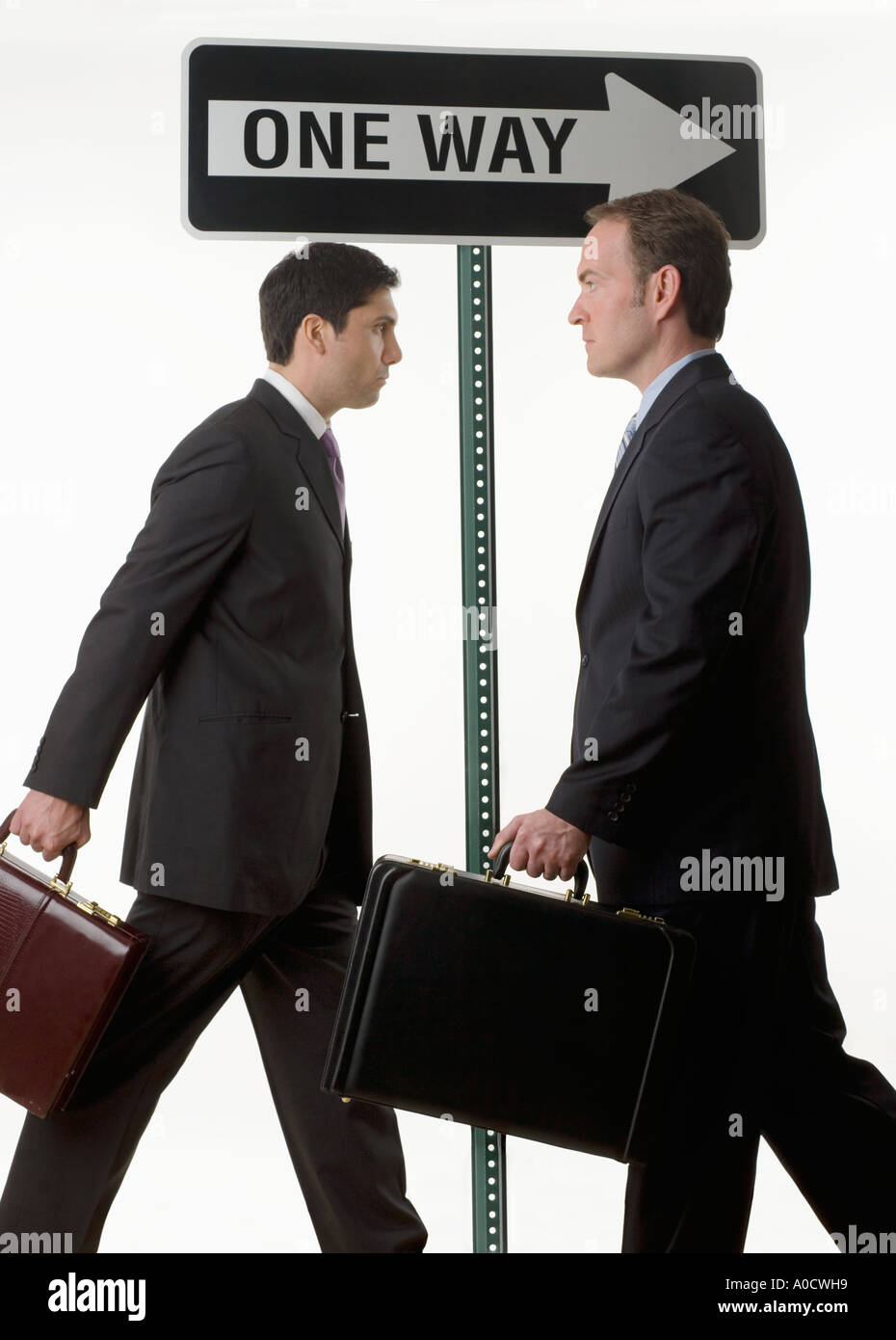 Businessmen at one way sign Stock Photo - Alamy
